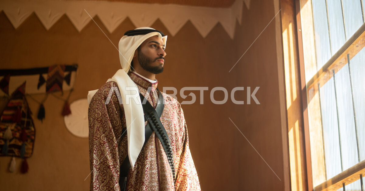 A Saudi Arabian Gulf man wears a traditional costume for national and ...