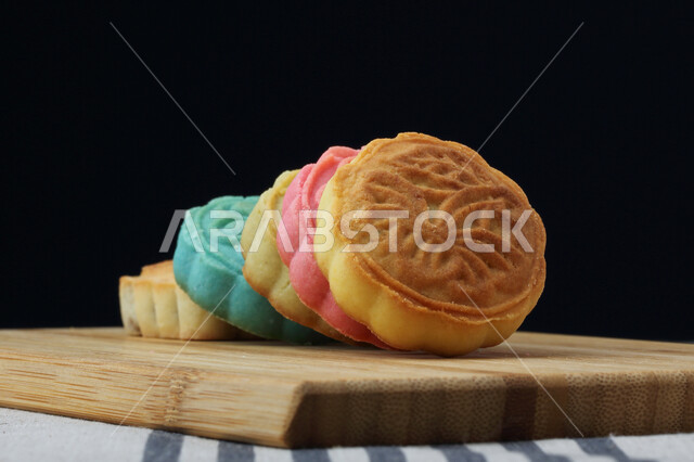 Square colored date maamoul, fragile popular sweets on a wooden board ...