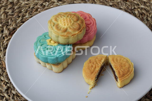 Square colored date maamoul, fragile popular sweets on a wooden board ...