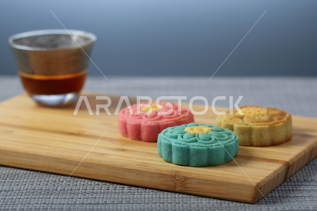 Square colored date maamoul, fragile popular sweets on a wooden board ...