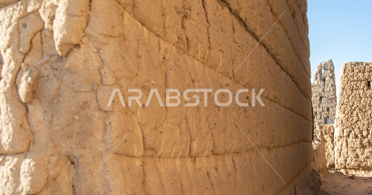 A wall of an old house made of clay and stacked stones in the Asir ...