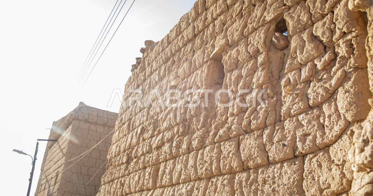 A wall of an old house made of clay and stacked stones in the Asir ...