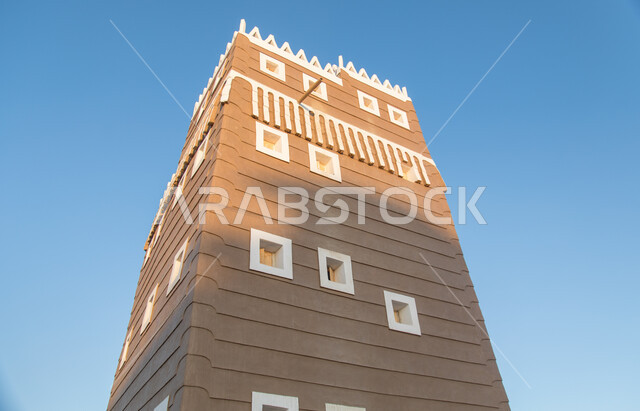 An old and restored heritage house with white windows in the Asir ...