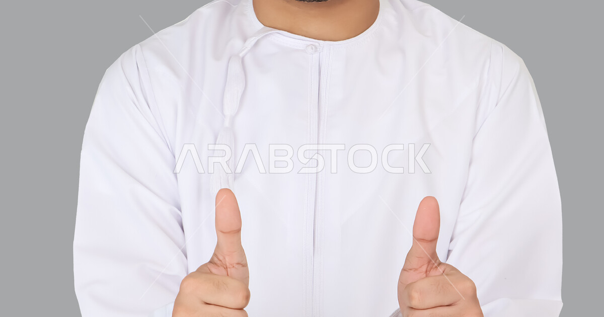 Portrait of an Omani Arab Gulf man raising the thumb up, smiling face ...