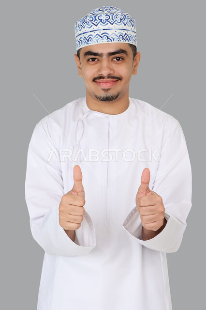 Portrait of an Omani Arab Gulf man raising the thumb up, smiling face ...