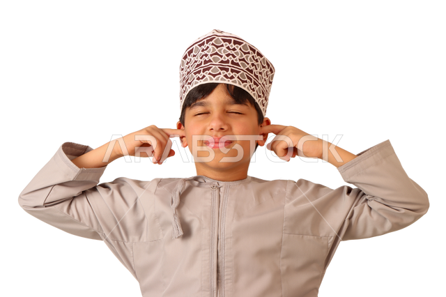 Portrait of an Omani Arab Gulf boy wearing the traditional Omani dress ...