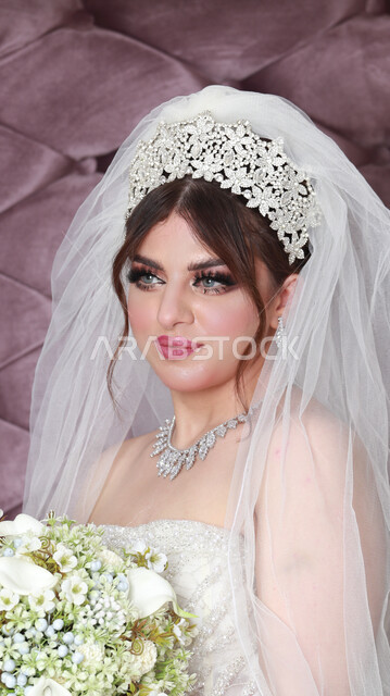 A Saudi Gulf Arab bride doing a photo session, holding a bride on her ...