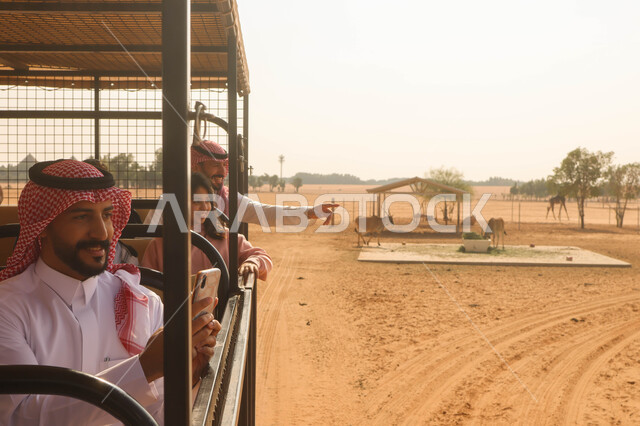 A Saudi Gulf Arab family on a tourist tour, a Saudi man taking souvenir ...