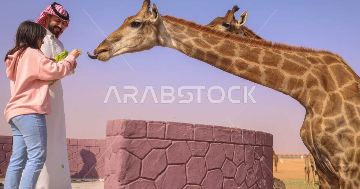 A Saudi Arabian Gulf man and his daughter spend fun times in the zoo in ...