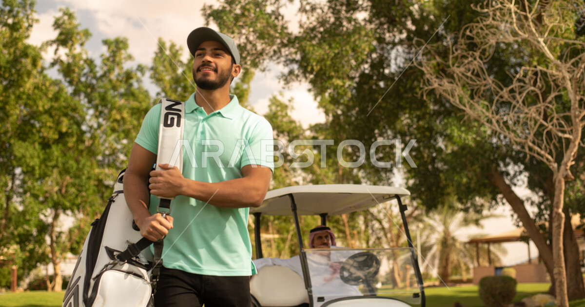 Two Saudi Arabian Gulf men on the golf course, an electric car ...