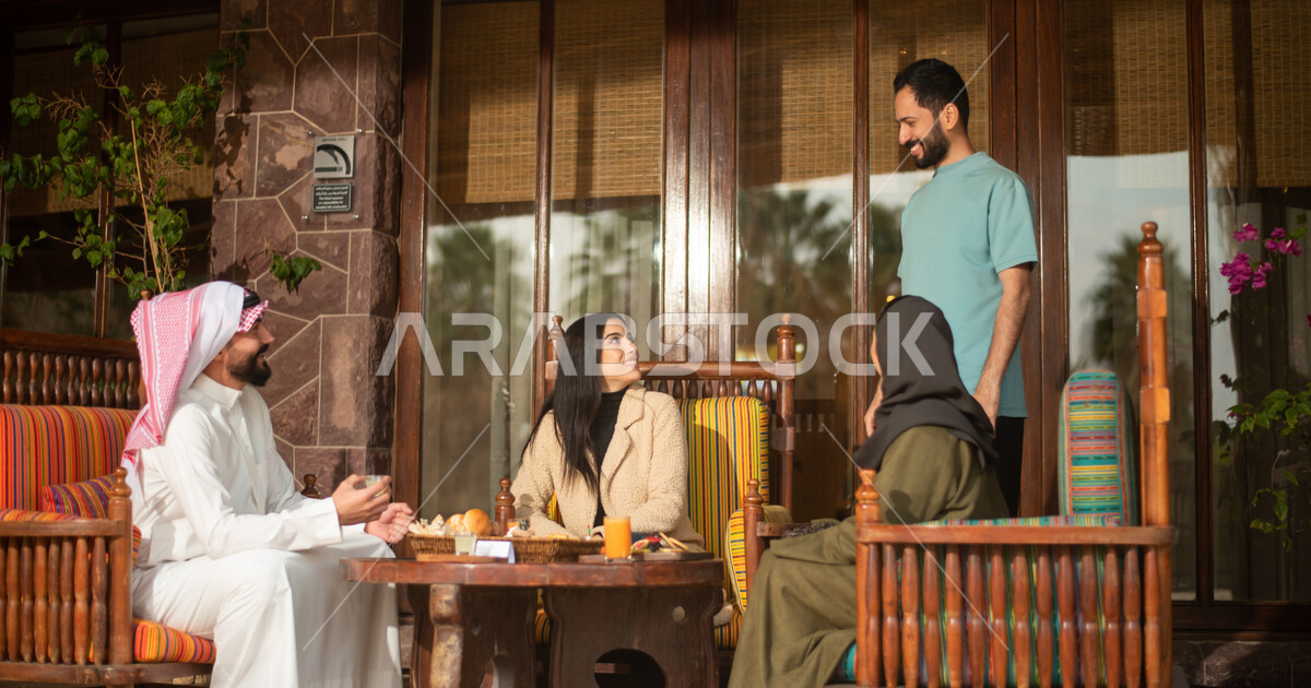 Saudi Gulf Arab friends enjoying an exchange of conversation in one of ...