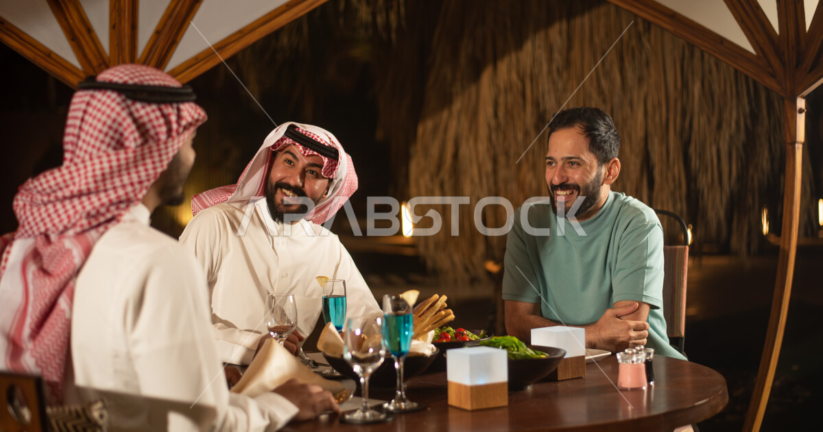 Young Saudi Gulf Arabs enjoying an exchange of conversation in a Saudi ...