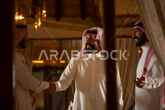 A group of Saudi Gulf Arab friends, two Saudi Arabian Gulf men wearing ...