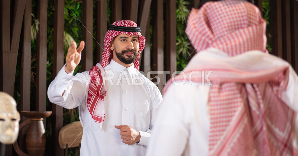 Two Saudi Arabian Gulf men in traditional Saudi dress, discussions and ...