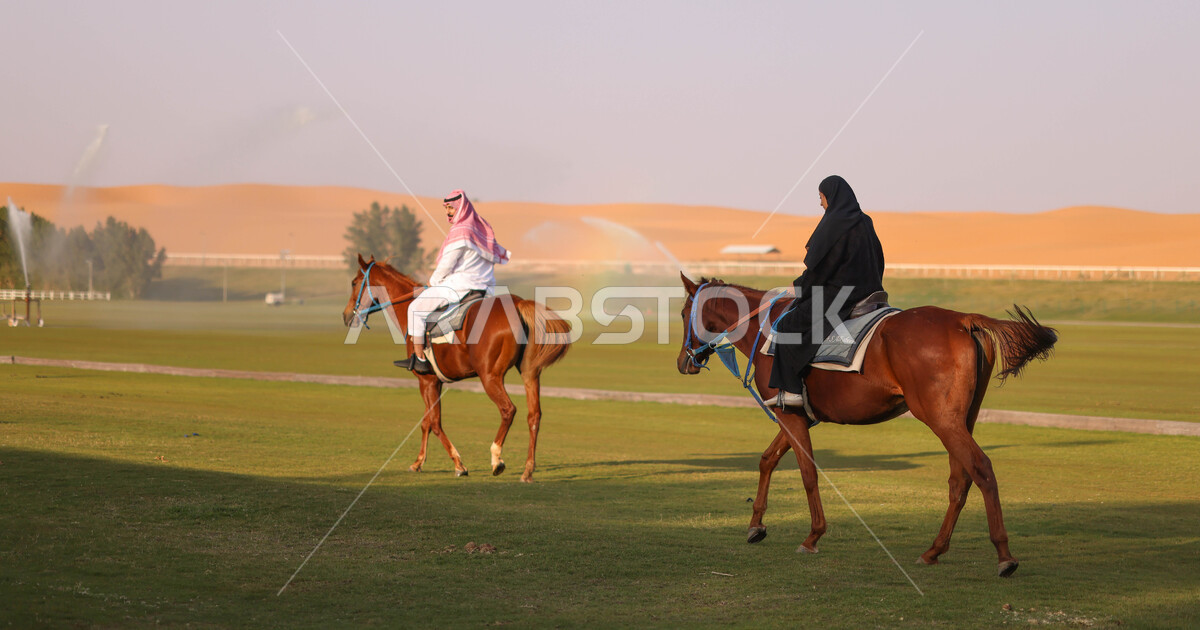 A Saudi Arabian Gulf couple riding horses, purebred Arabian horses ...