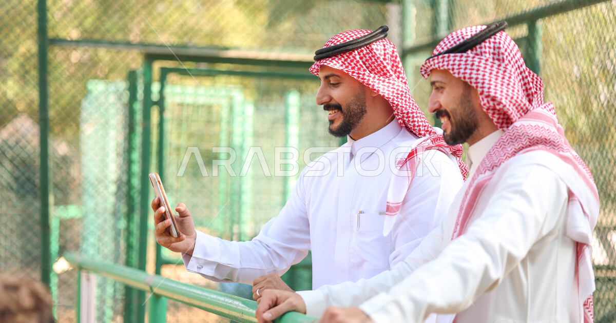 Two Saudi Arabian Gulf men in the zoo in the Kingdom of Saudi Arabia ...