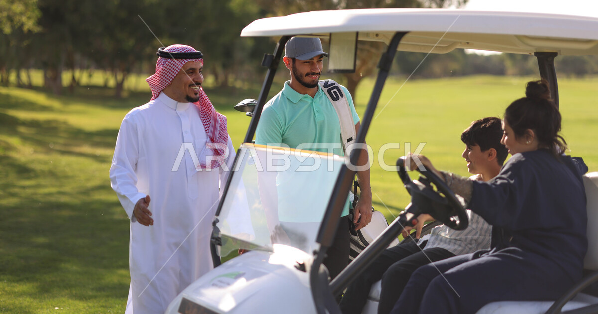A Saudi Arab Gulf family in the golf course, playing golf on large ...