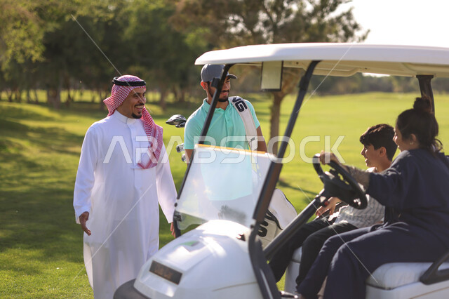 A Saudi Arab Gulf family in the golf course, playing golf on large ...