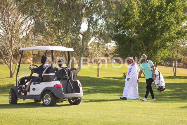 A Saudi Arab Gulf family in the golf course, playing golf on large ...