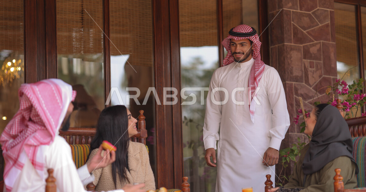 Saudi Gulf Arab friends enjoying an exchange of conversation in a Saudi ...