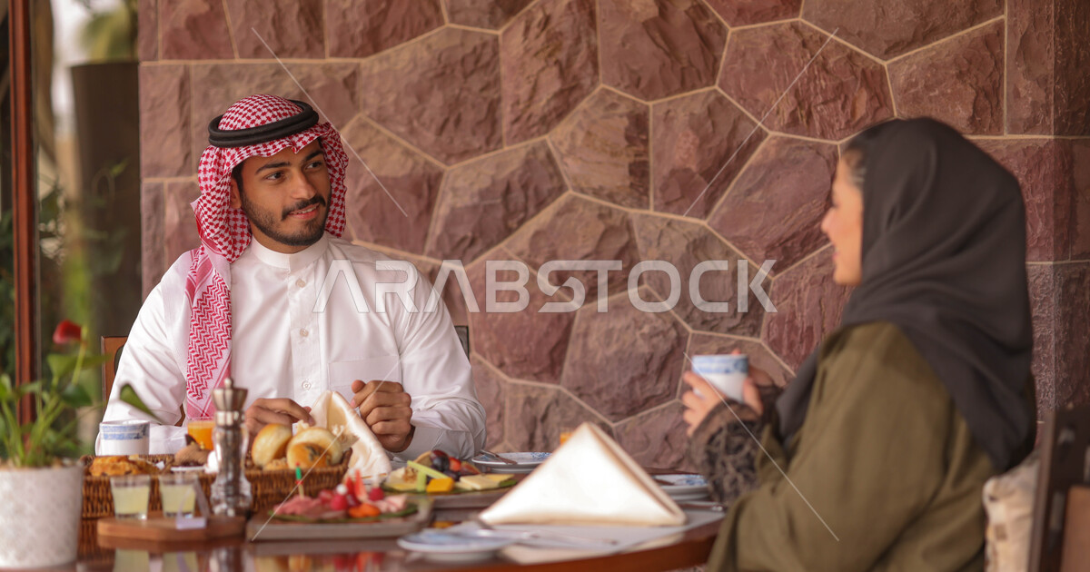 A Saudi Arab Gulf couple enjoying an exchange of conversation in a ...