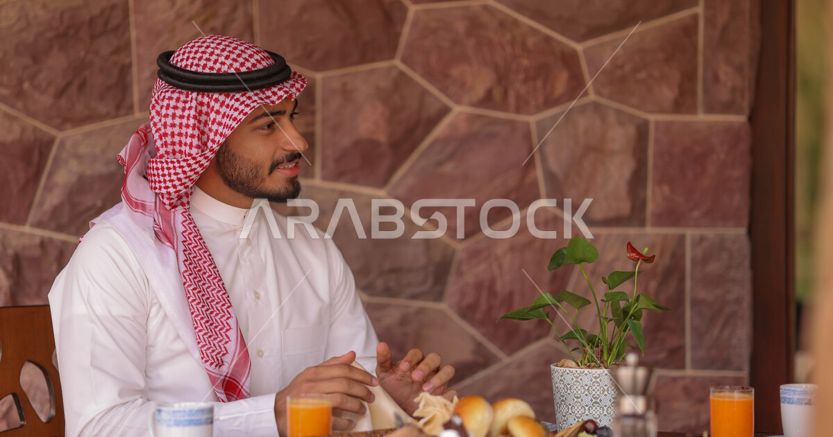 A Saudi Arabian Gulf man spending pleasant times in a Saudi cafe, cold ...