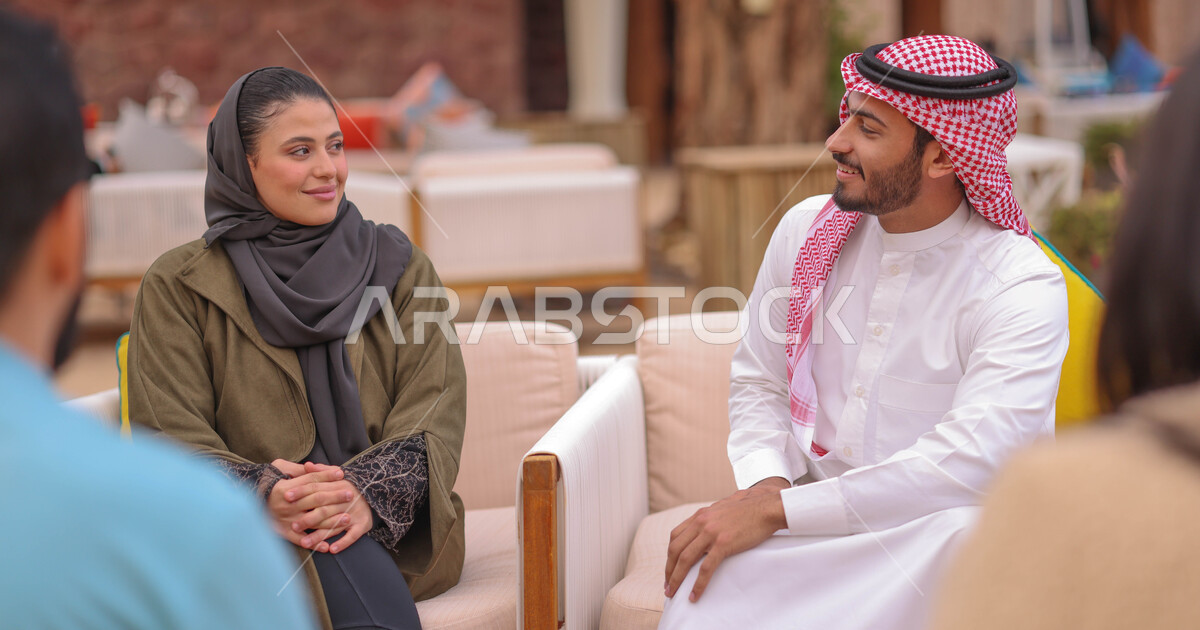 Saudi Gulf Arab friends enjoying exchanging conversations in one of the ...