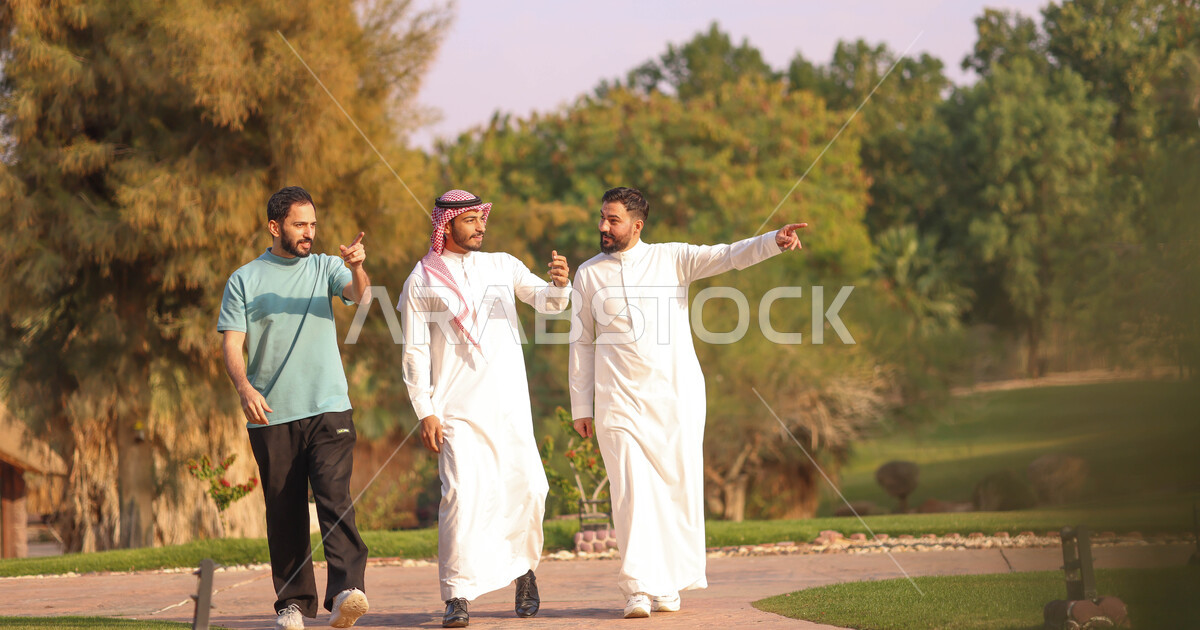 Young Saudi Gulf Arabs wandering in a public park, spending enjoyable ...