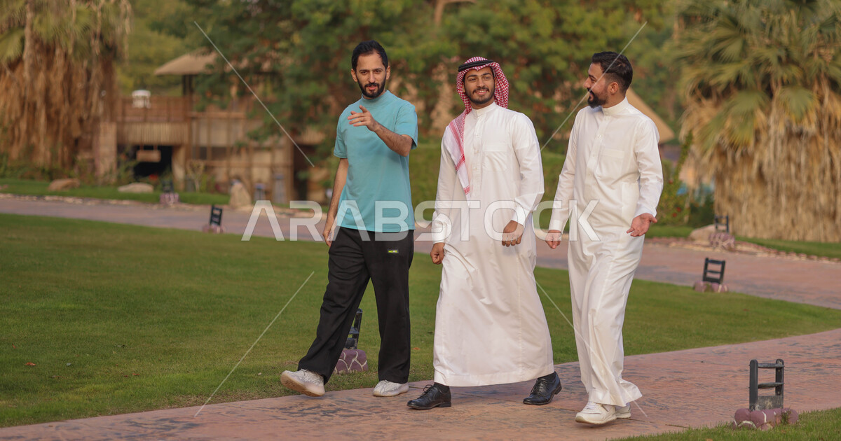 Young Saudi Gulf Arabs wandering in a public park, spending enjoyable ...