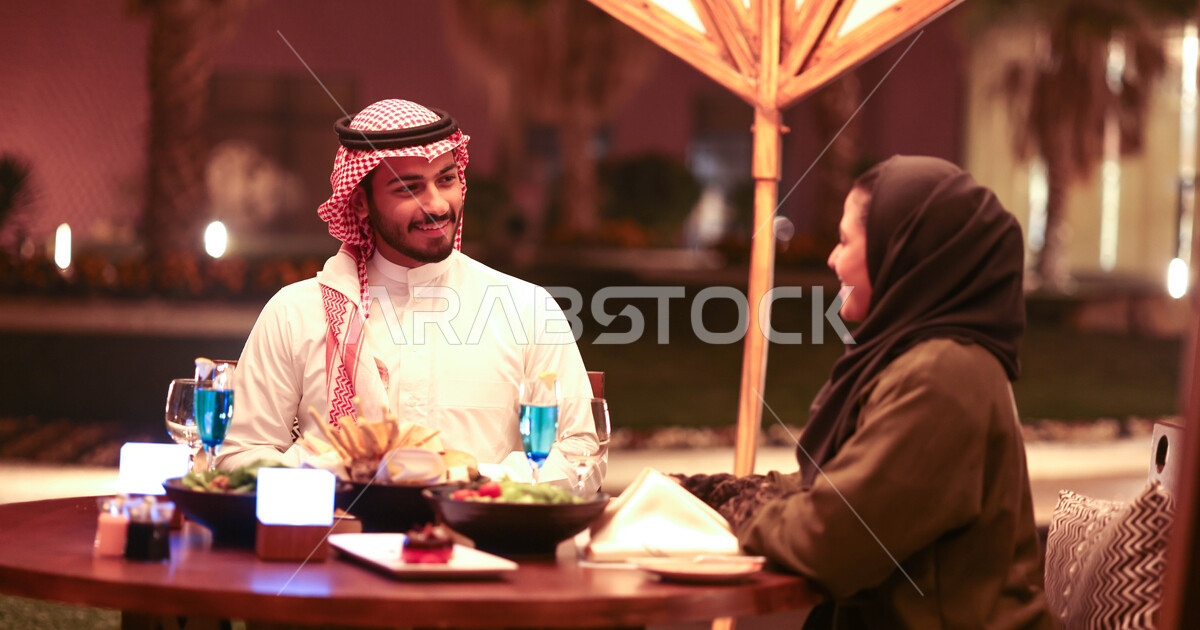 A Saudi Arab Gulf couple enjoying an exchange of conversation in a ...