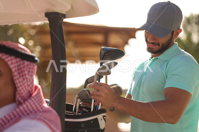 Saudi Arabian Gulf man on the golf course, getting ready to play golf ...