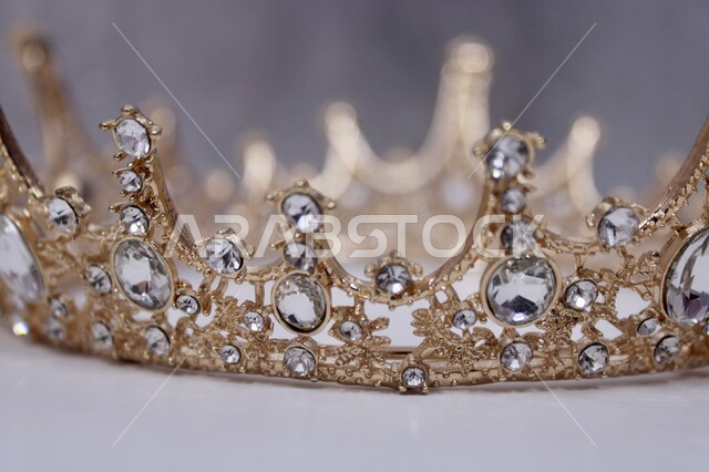 A close-up of a golden bridal tiara studded with diamonds, zircon lobes ...