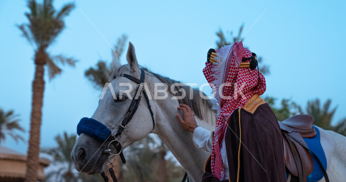 A Saudi Arab Gulf knight wearing a traditional costume and standing ...