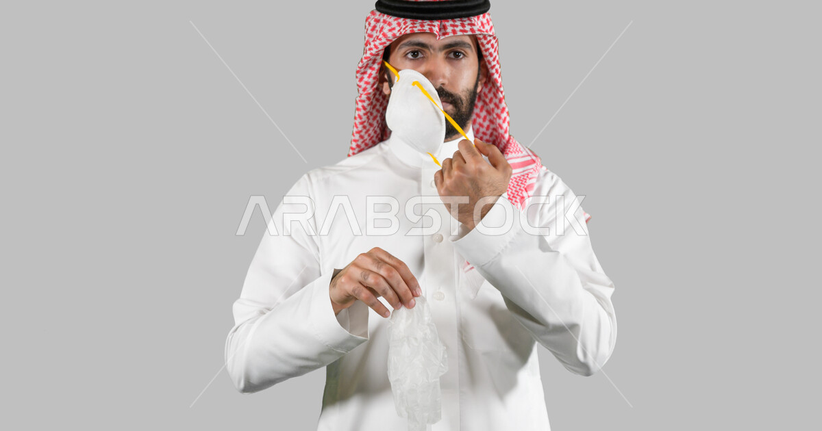 Portrait of a Saudi Arabian Gulf youth wearing a medical mask to ...