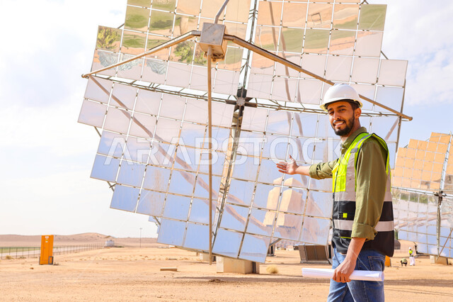 A Saudi Arabian Gulf engineer, wearing a helmet and a protective vest ...
