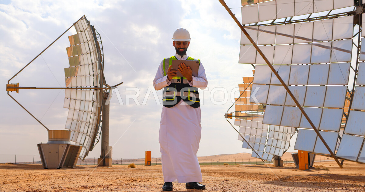 Arab Gulf Saudi engineer, wearing a helmet and a protective vest ...