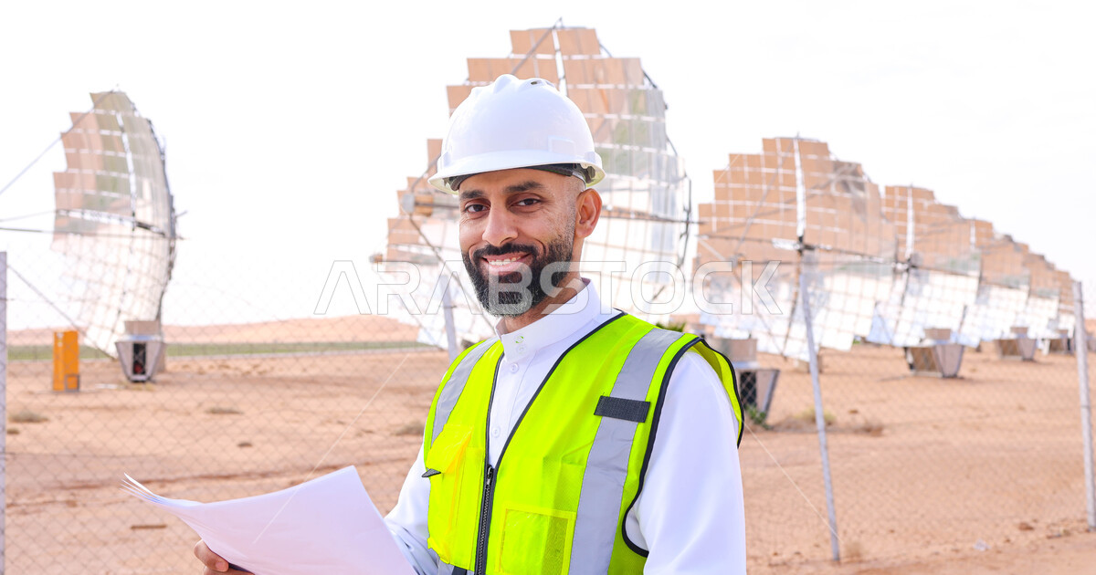 A Saudi Arabian Gulf engineer, wearing a helmet and a protective vest ...