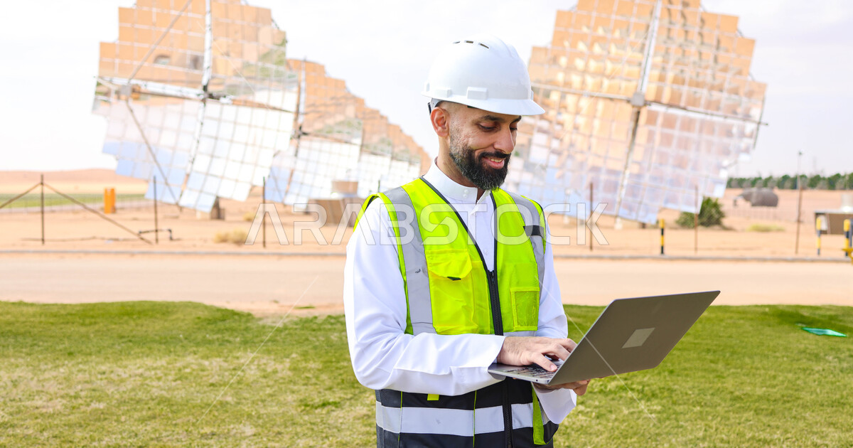 Arab Gulf Saudi engineer, wearing a helmet and a protective vest ...