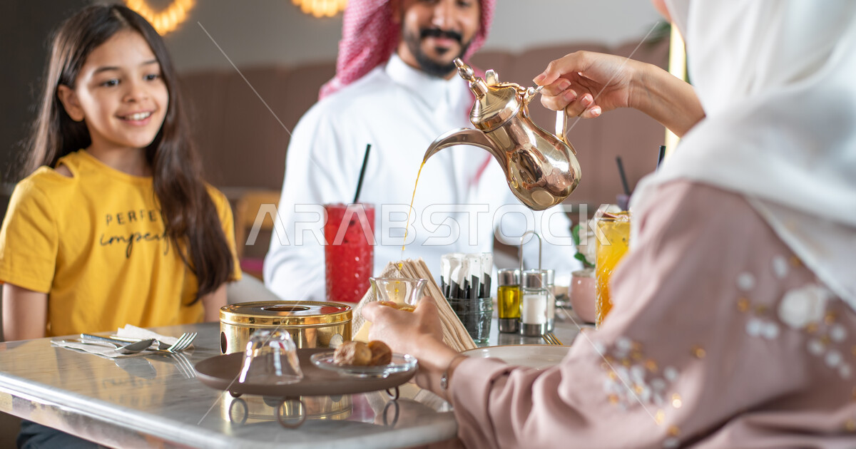 Cafes and restaurants in Saudi Arabia, a Saudi Gulf Arab family sitting ...