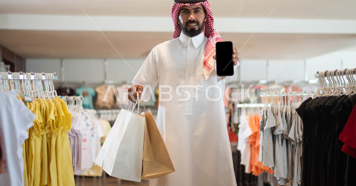 A young Arab Gulf Saudi man wearing the traditional Saudi dress ...