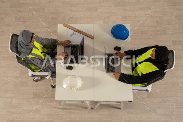 Completing work tasks through a laptop computer, an overhead vertical ...