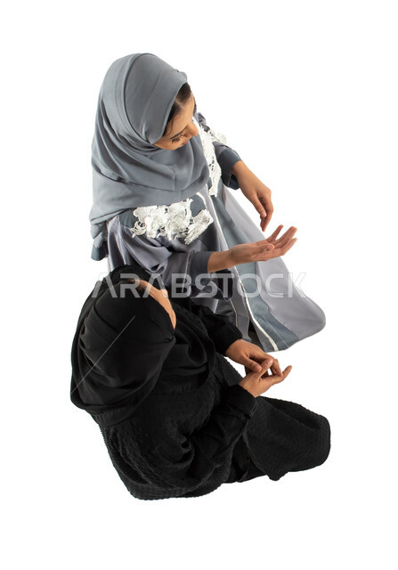 Two Saudi Gulf women wearing the Gulf abaya, a vertical overhead image ...