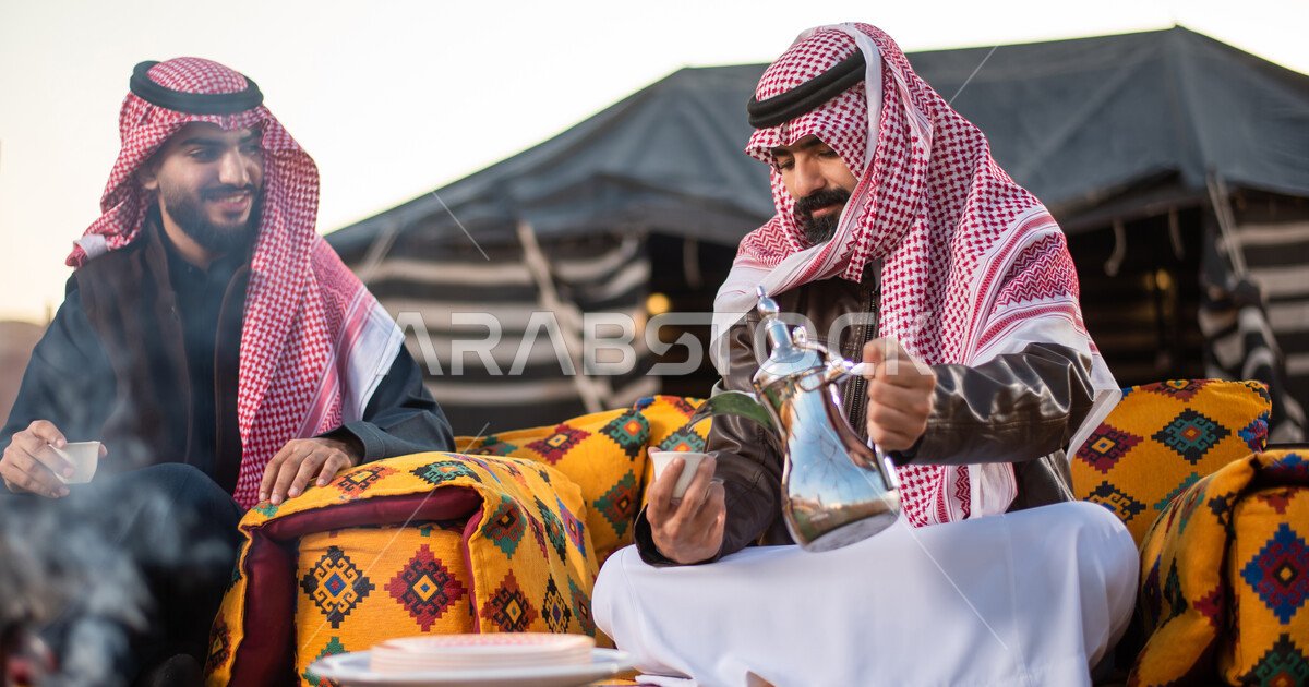 Pouring coffee from a copper dallah, popular tents in the deserts of ...