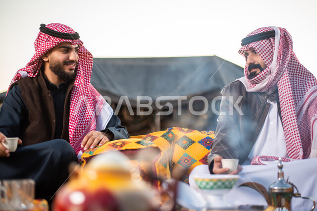 Arab generosity and hospitality, serving hot drinks, pouring coffee ...