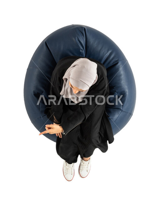 Sitting on a comfortable chair, portrait of an overhead, vertical ...