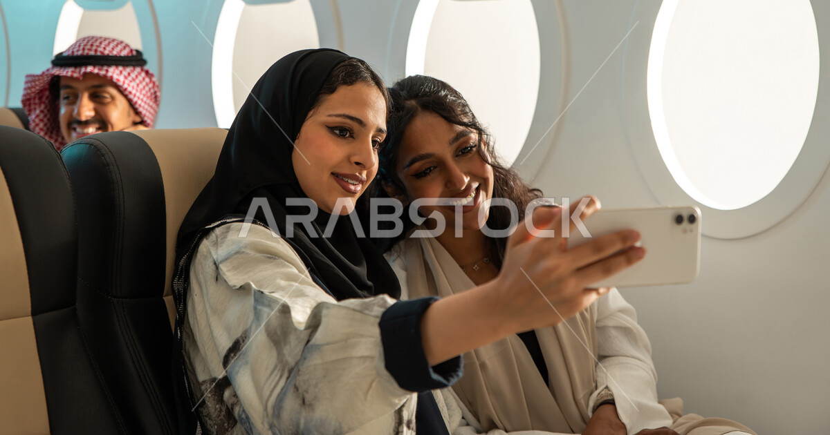 Two Saudi Arabian Gulf women taking souvenir photos, spending fun times ...