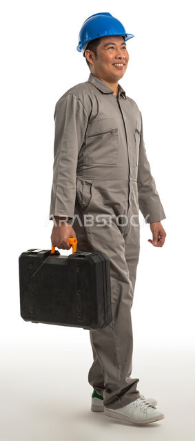 Portrait of a Filipino construction worker wearing a protective helmet ...