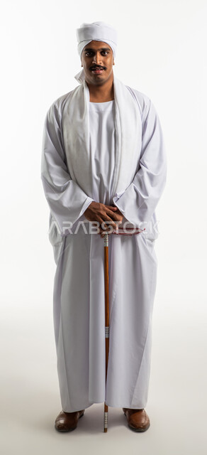 Portrait of an Egyptian farmer holding a wooden stick in his hand and ...