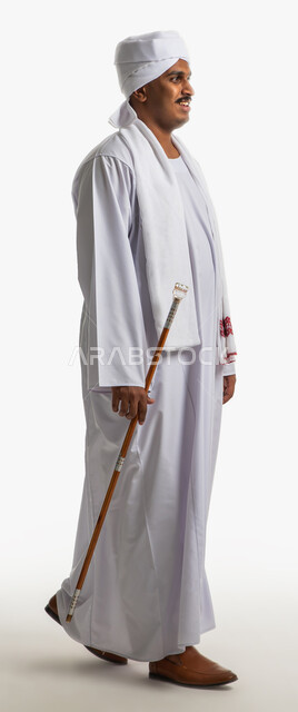 Portrait of an Egyptian farmer holding a wooden stick in his hand and ...