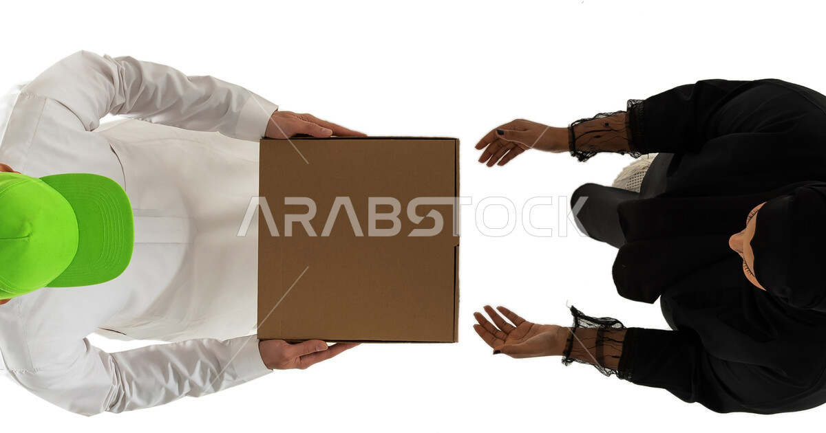 A woman receives the order from a delivery representative wearing a ...